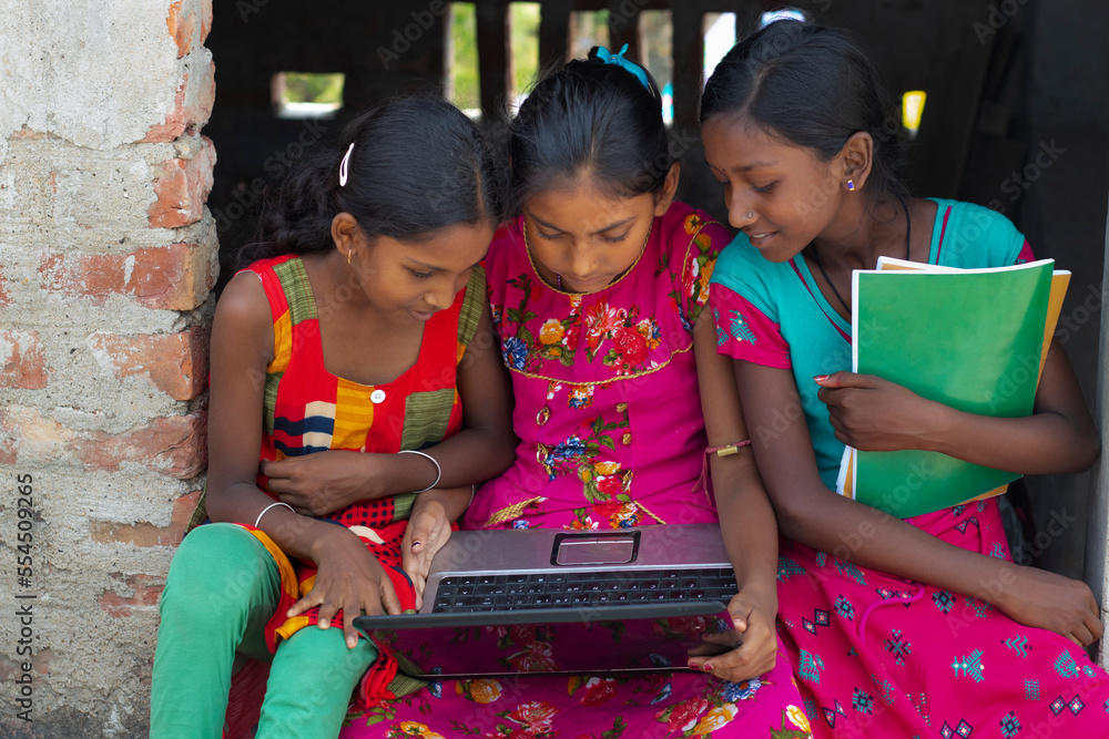 School Students Girls using laptop while studying at home Stock Photo ...