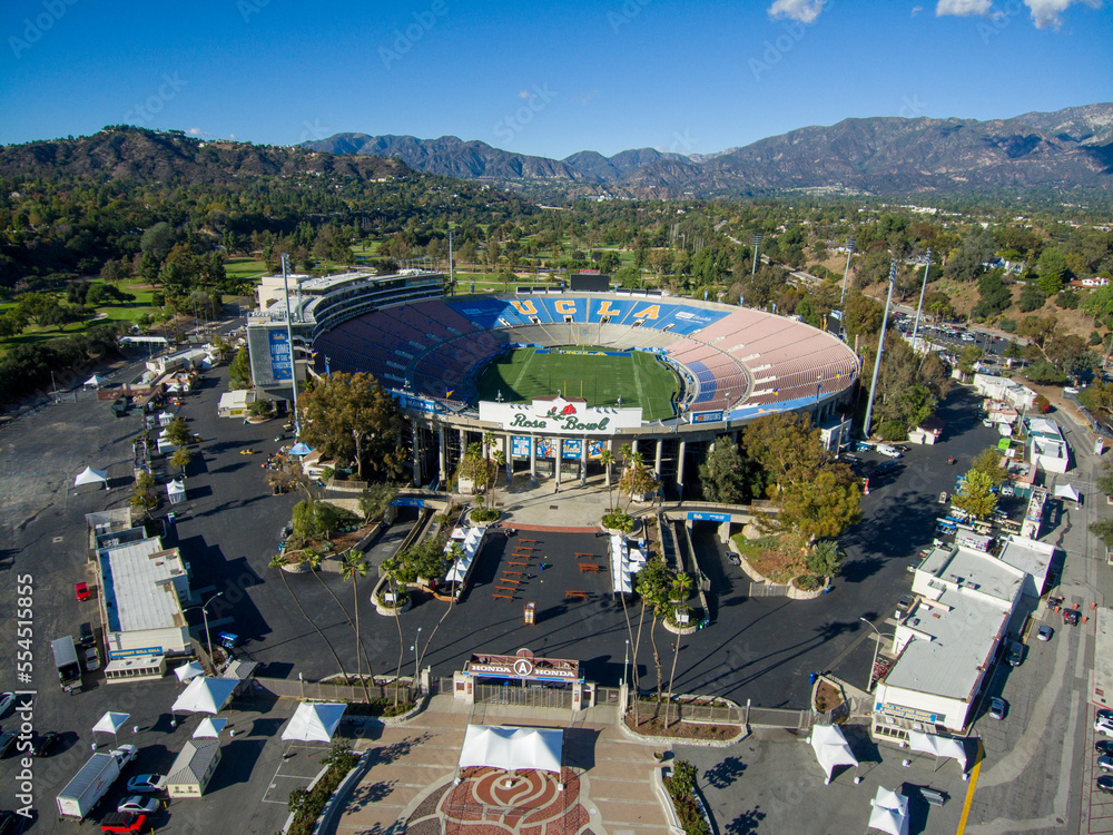 aerial shot of the Rose Bowl Stadium surrounded by lush green tree ...