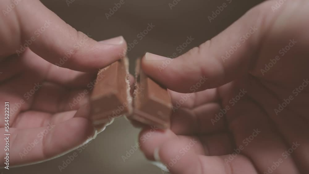Woman breaks chocolate bar. Hands breaking, cracking dark milk ...