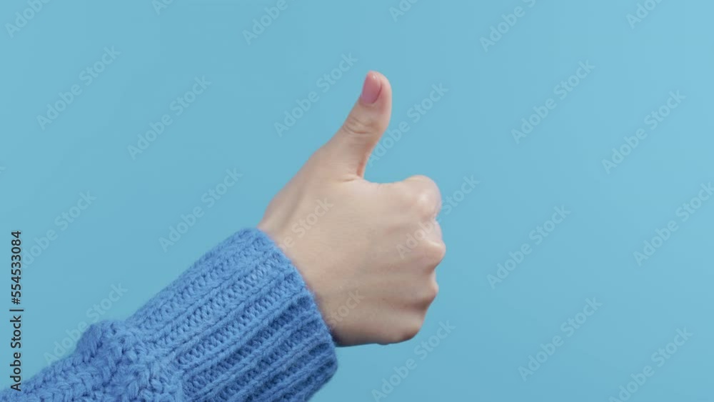 Unrecognizable woman makes hand sign like, thumb up gesture. Correct ...