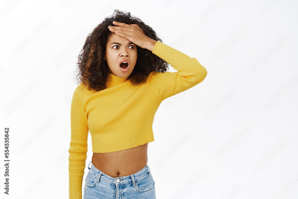 Portrait of shocked, concerned black woman, slap her forehead, looking ...