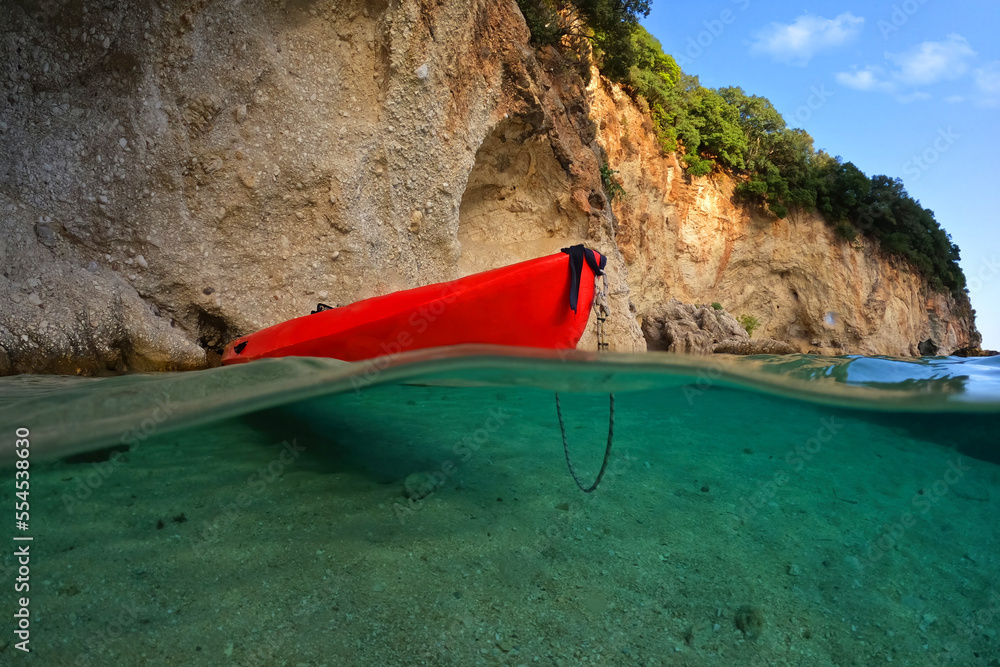 Underwater split photo of sport canoe in crystal clear emerald sea and ...