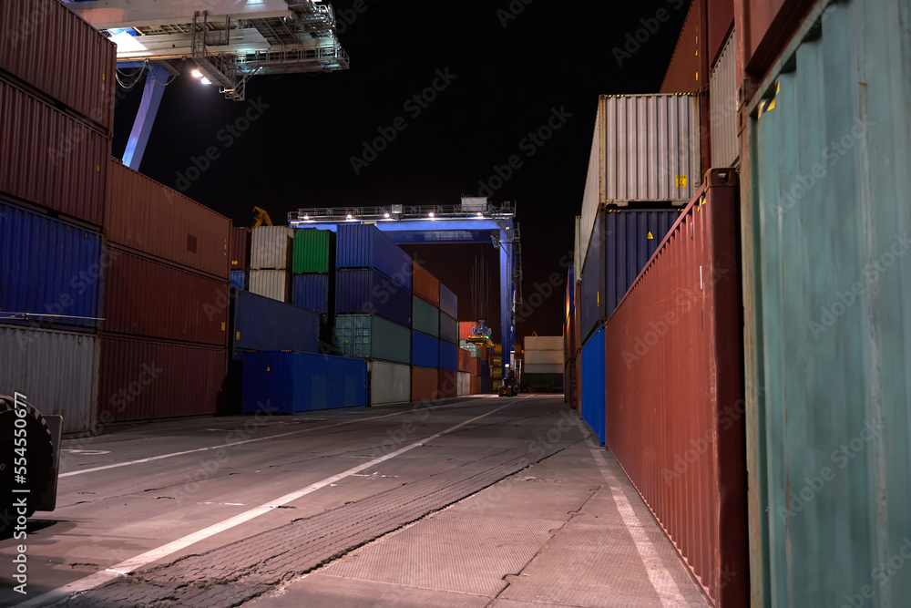 operation of container terminal at night. Unloading container ship at ...