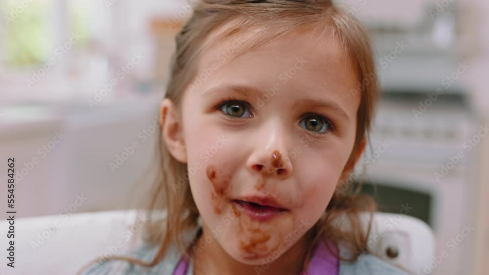 Girl eating with chocolate on happy face, messy hands and sitting in ...