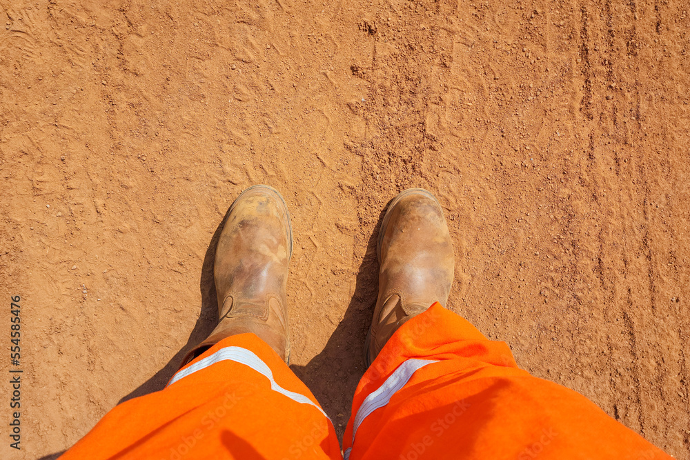 Close-up at operation worker foot which is wearied leather safety boots ...