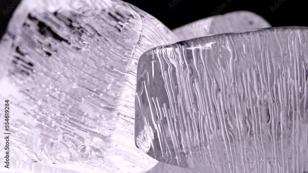 Pieces of ice with frozen air bubbles shine through with light. Frozen ...