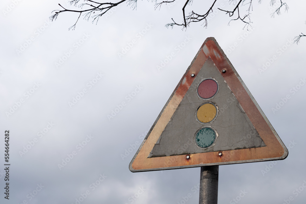Warning traffic sign for a traffic light in worn out condition with a ...