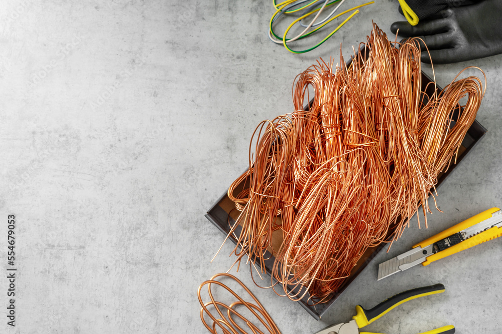 Copper scrap on a gray table top view. Metal electrical cable without ...