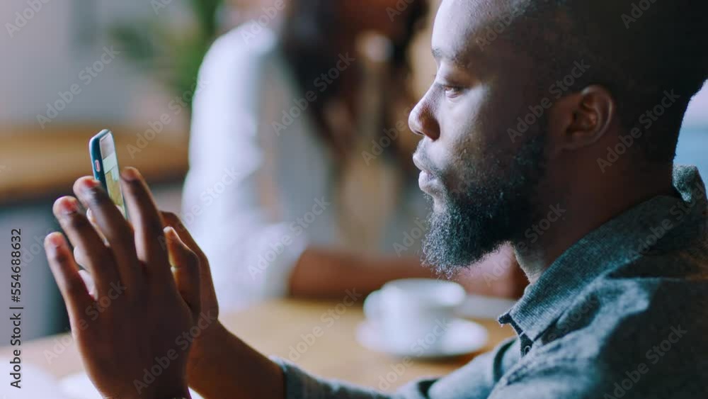 Black man in cafe, phone and typing while on lunch break, relax and ...