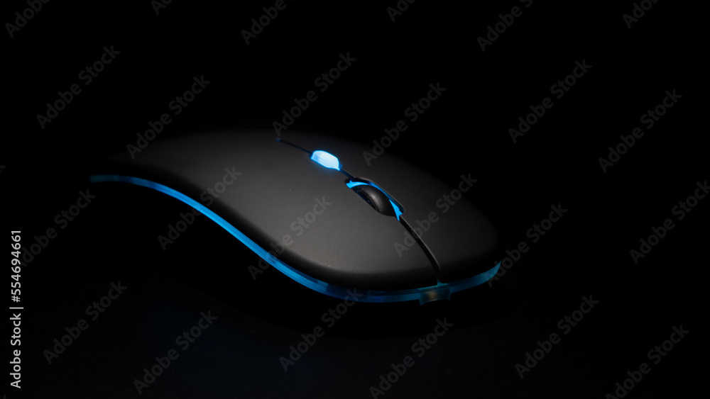 glowing wireless black computer mouse in the dark Stock Photo | Adobe Stock