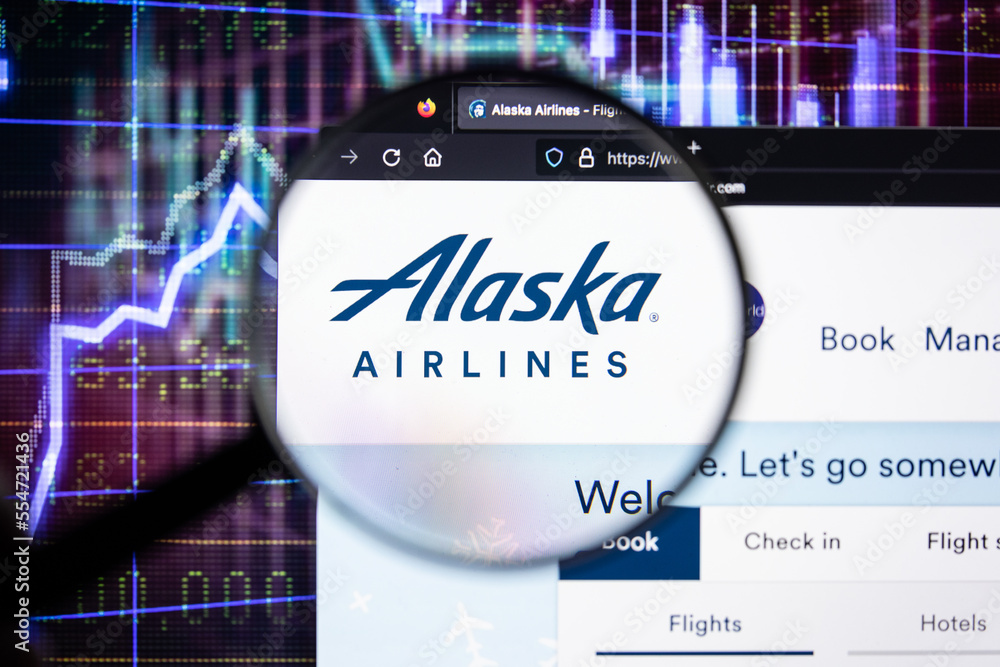 Alaska Airlines company logo on a website with blurry stock market ...