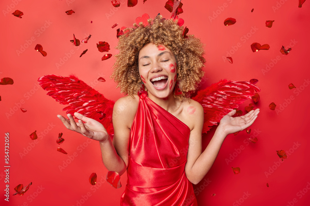 Happy Valentines Day. Glad curly haired young woman wears dress annd ...