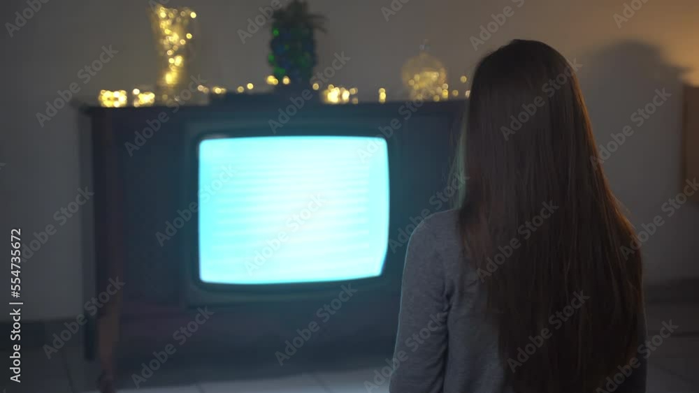 Problem of TV addiction of modern society, woman sitting on the floor ...