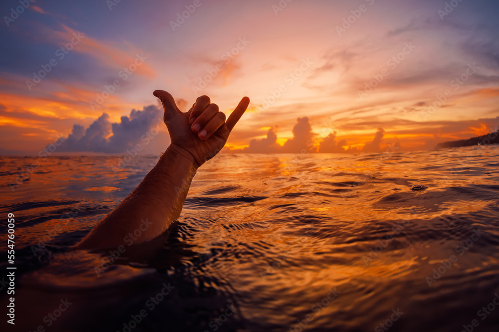Shaka symbol with bright sunset in ocean. Lifestyle surfing concept ...
