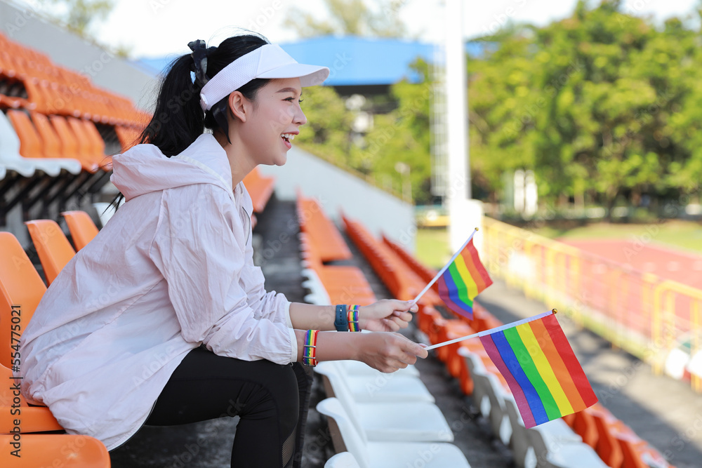 Happy and excited young female asian transgender LGBT sport fan ...