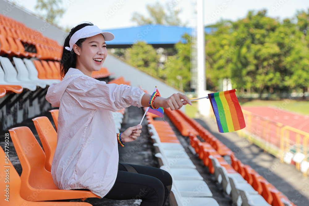 Happy and excited young female asian transgender LGBT sport fan ...