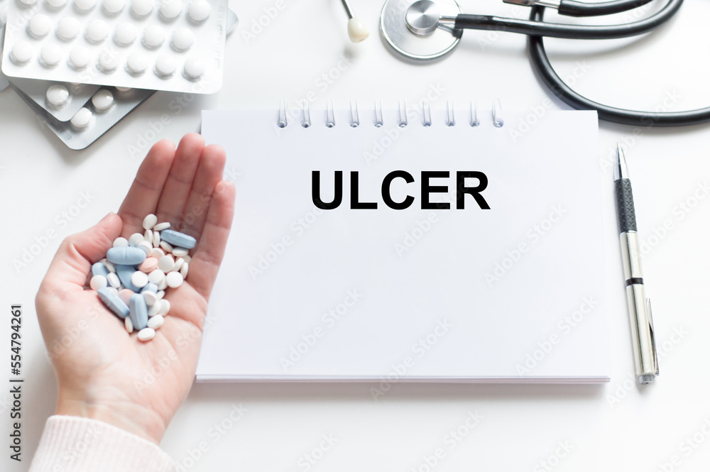Medical and stomach ulcer symbol. Doctor hand, metalic pen. White note ...