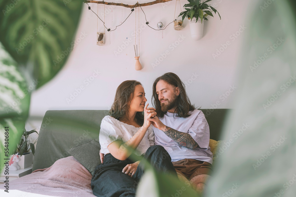 Happy romantic couple sitting on bed in at home Stock Photo | Adobe Stock