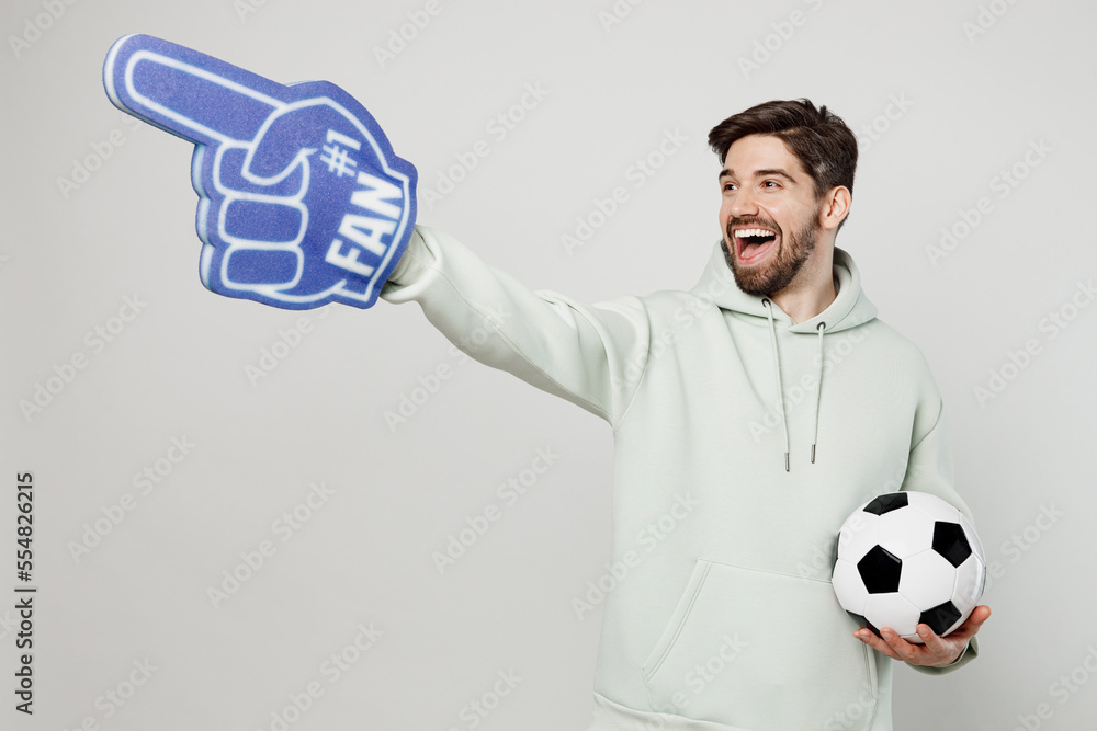 Young happy man fan wears mint hoody point aside foam 1 fan glove ...