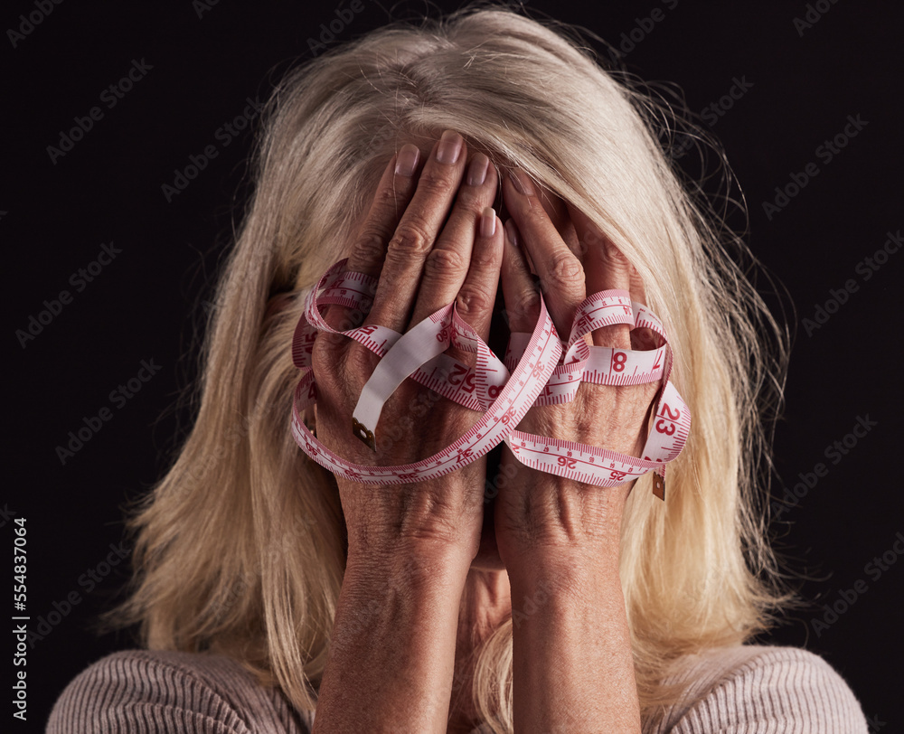 Hands, tape measure and anorexia with a woman holding her face in ...
