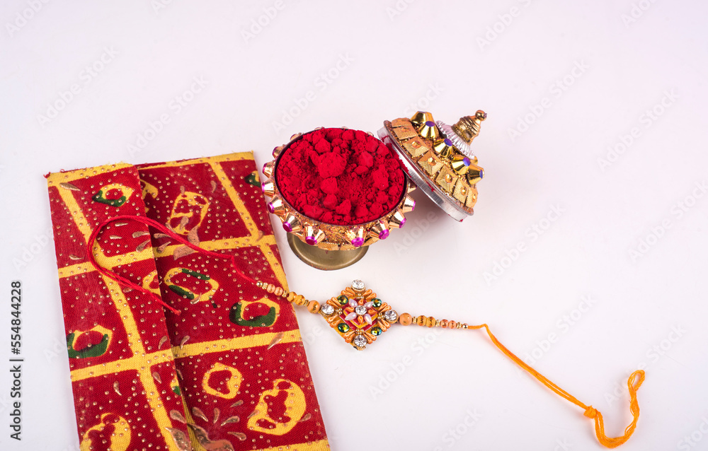 Indian traditional Festival Rakhi with rice grains, kumkum and gift ...