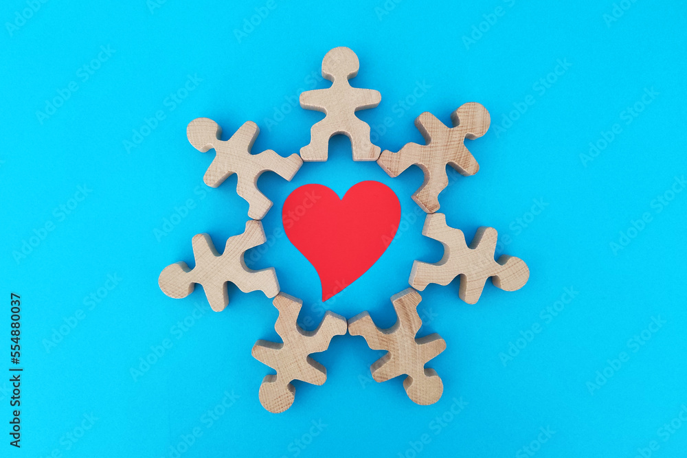 Group of people holding hands together making round circle with a heart ...