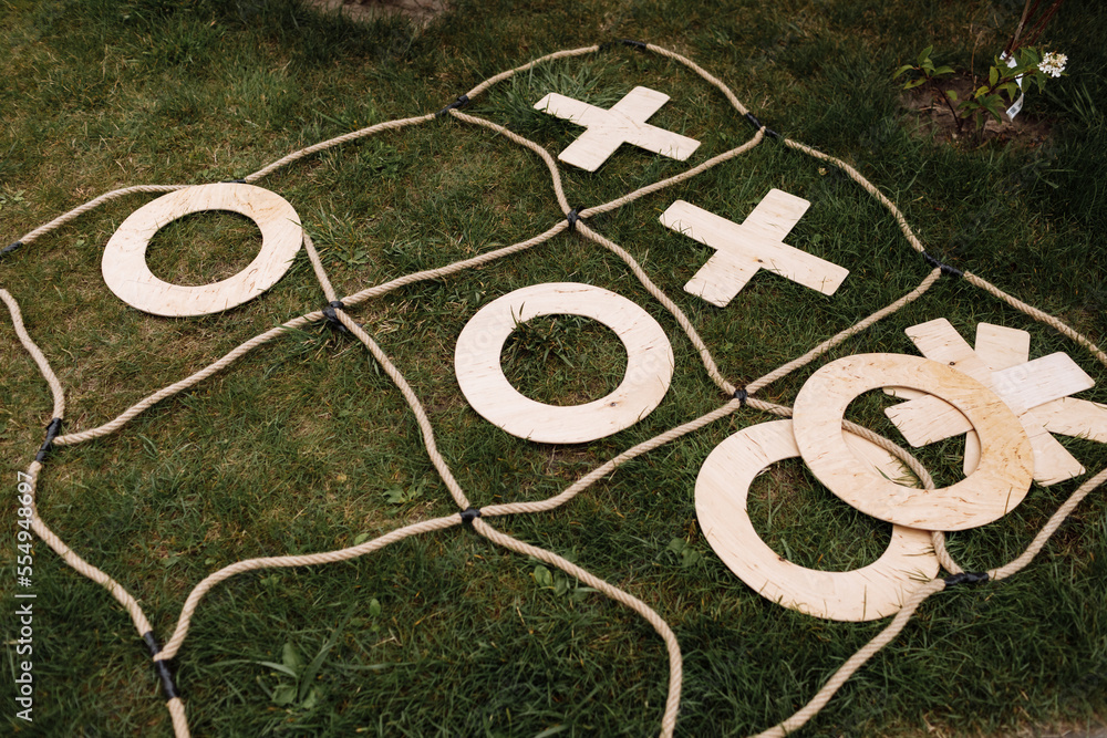 Big wooden Tic Tac Toe game outdoors on green grass background ...
