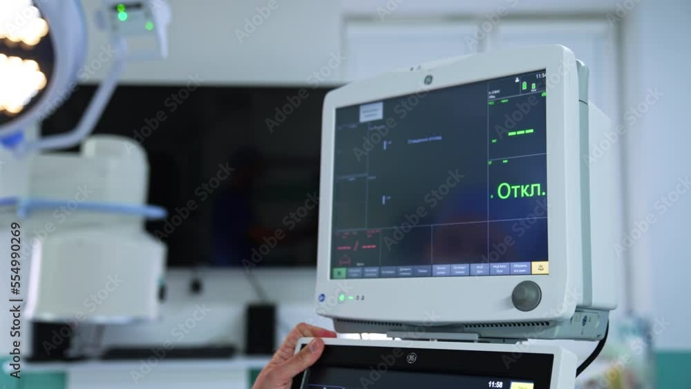 Doctor’s hand turn the screens of lung ventilator system. The monitors ...