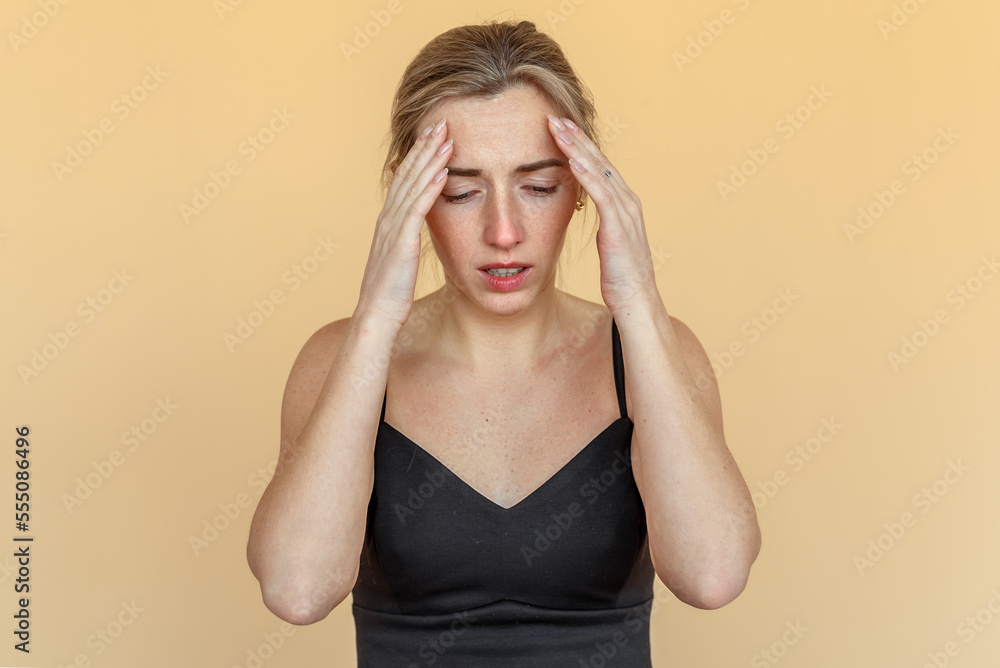 Portrait of the stressed young woman in panic, holding hands on head ...