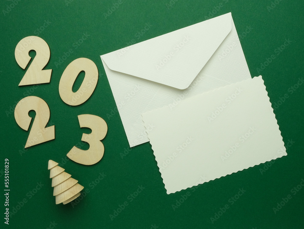 An empty card on a green background, the numbers 2023 and a Christmas ...