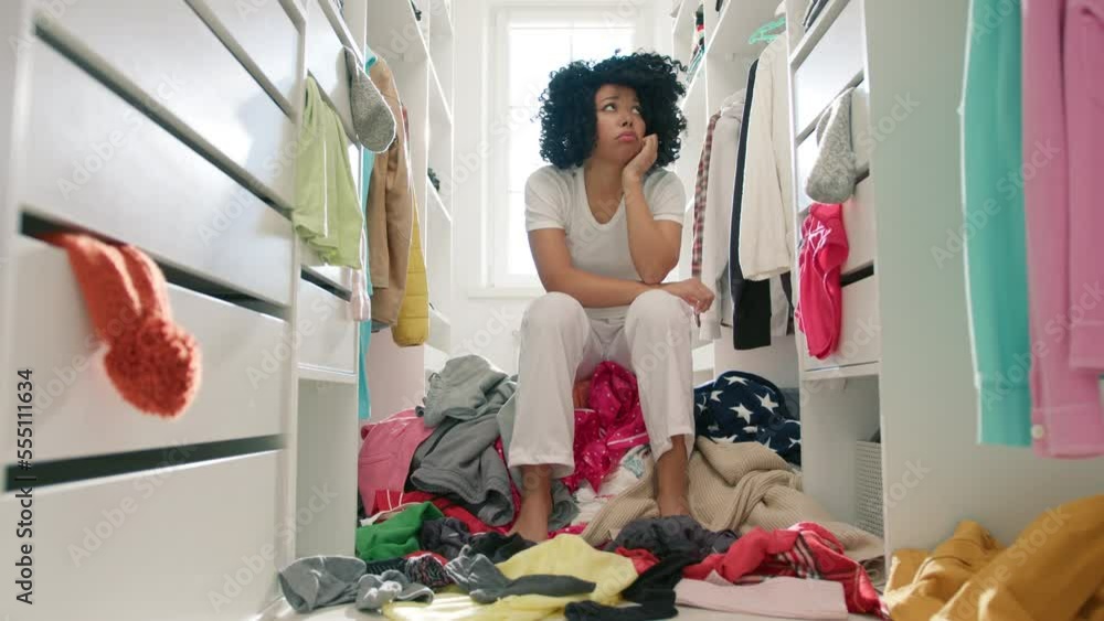 Stockvideon Slow motion of funny sad woman of color sitting in the ...