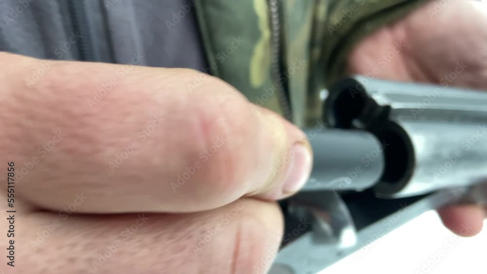 Shotgun in hunter hand. Hunter loads Cartridge (firearms) with shot ...