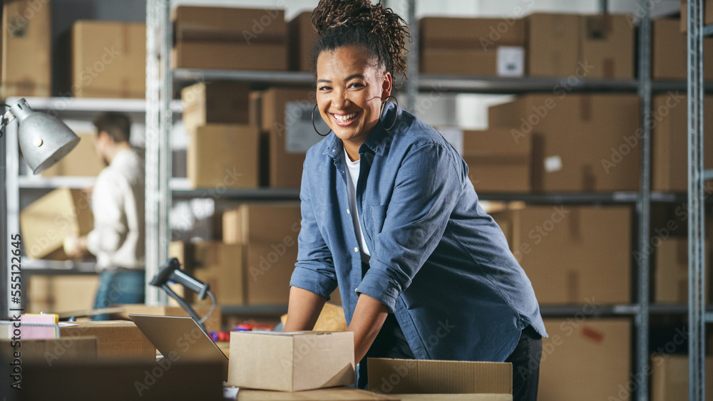 Portrait of a Happy African Small Business Owner Working on Laptop in ...