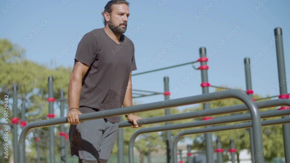Athlete with prosthetic leg doing hanging leg raises while working out ...
