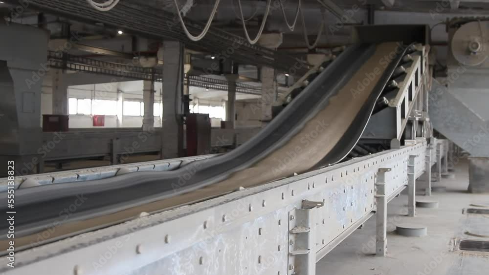 Grain moves along a conveyor belt. Wheat is transported to drying and ...