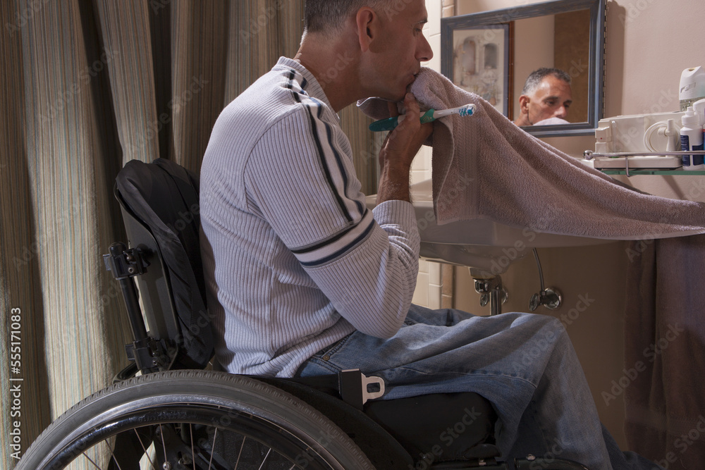 Man with spinal cord injury in a wheelchair brushing his teeth Stock ...