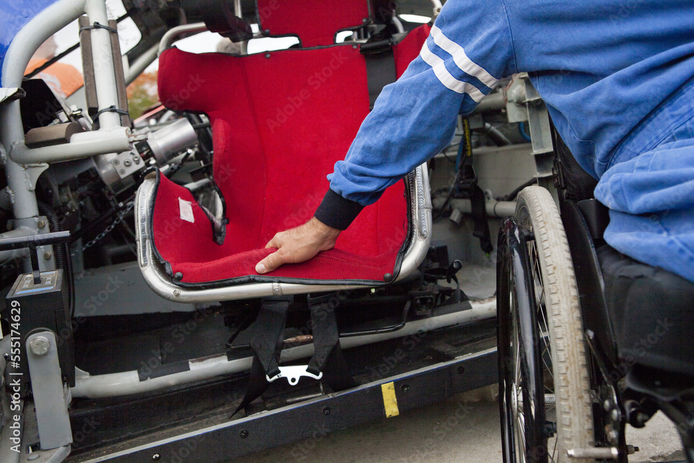 Racer with spinal cord injury in wheelchair at swing away safety roll ...