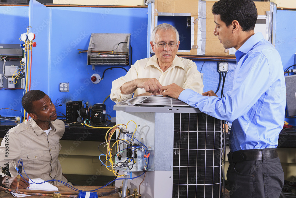 Instructor training students about air conditioning units in HVAC classroom Stock Photo | Adobe ...