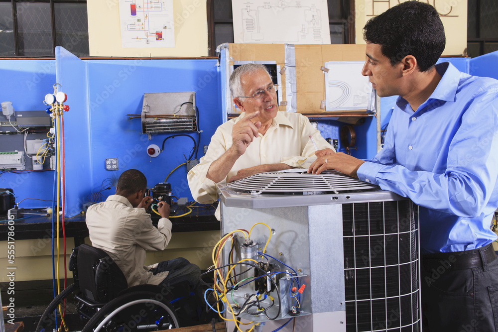 Instructor training students about air conditioning units in HVAC ...
