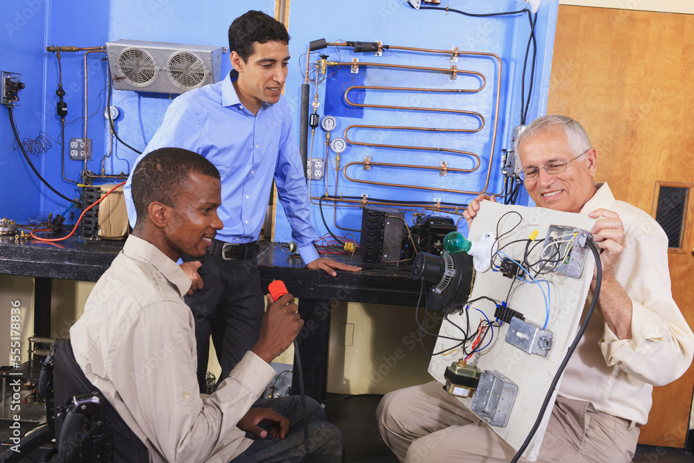 Instructor demonstrating air conditioner control system on demo board ...