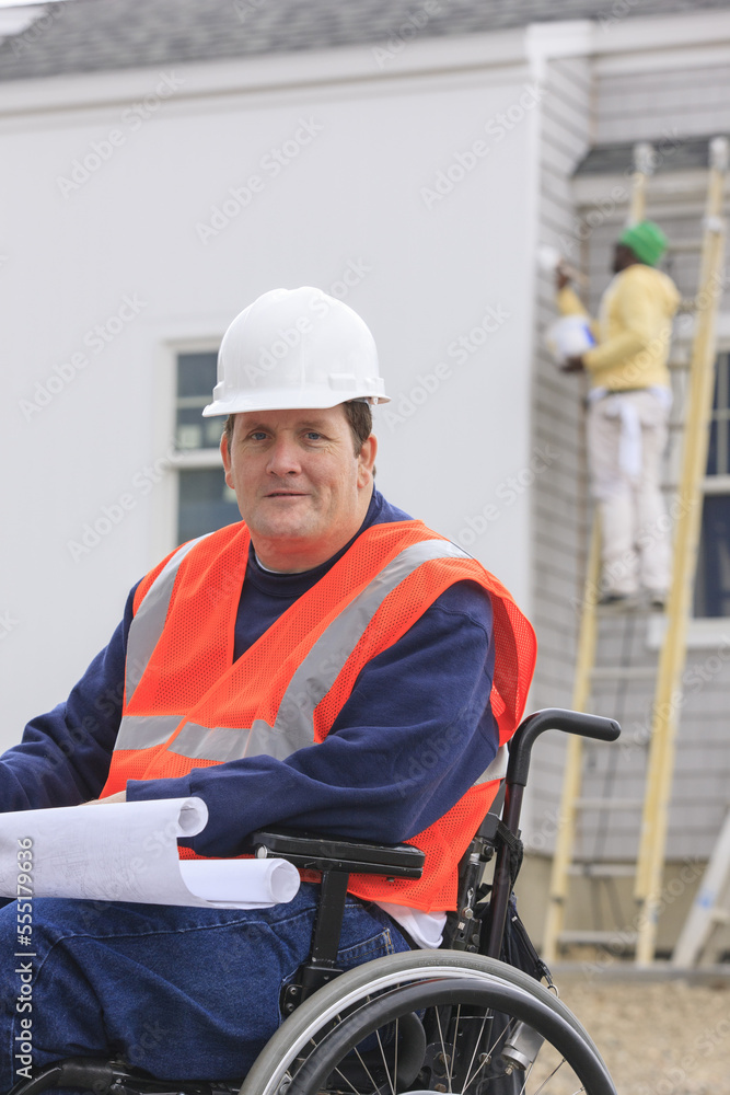 Construction engineer with spinal cord injury with house plans at ...