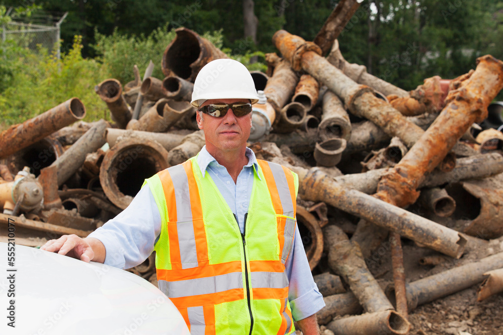 Engineer standing with old water pipes in the background Stock Photo ...