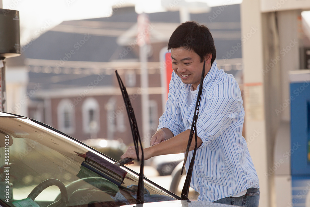 Chinese man washing his car windshield Stock Photo | Adobe Stock