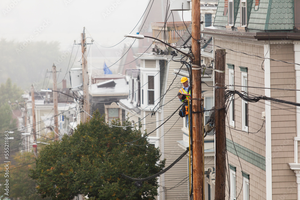 Cable lineman working from ladder on cable distribution wiring Stock ...