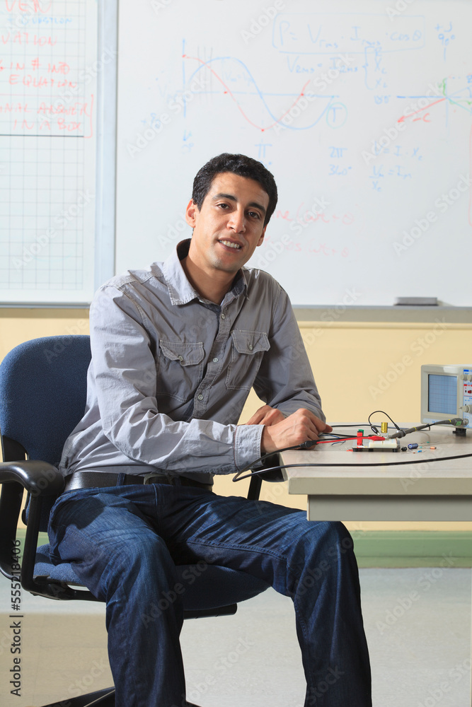 Engineering student sitting in classroom with oscilloscope and ...
