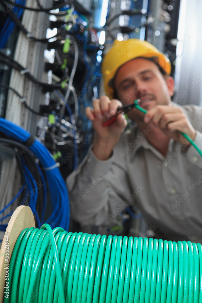 Network engineer cutting cable termination in network data center Stock ...