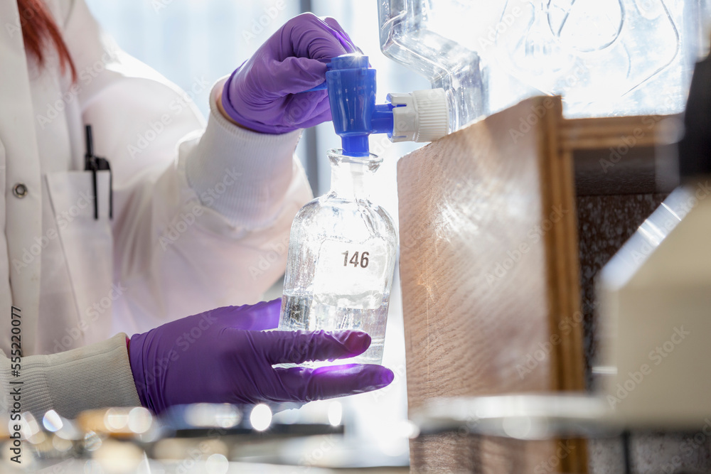 Lab chemist collecting reagent Stock Photo | Adobe Stock