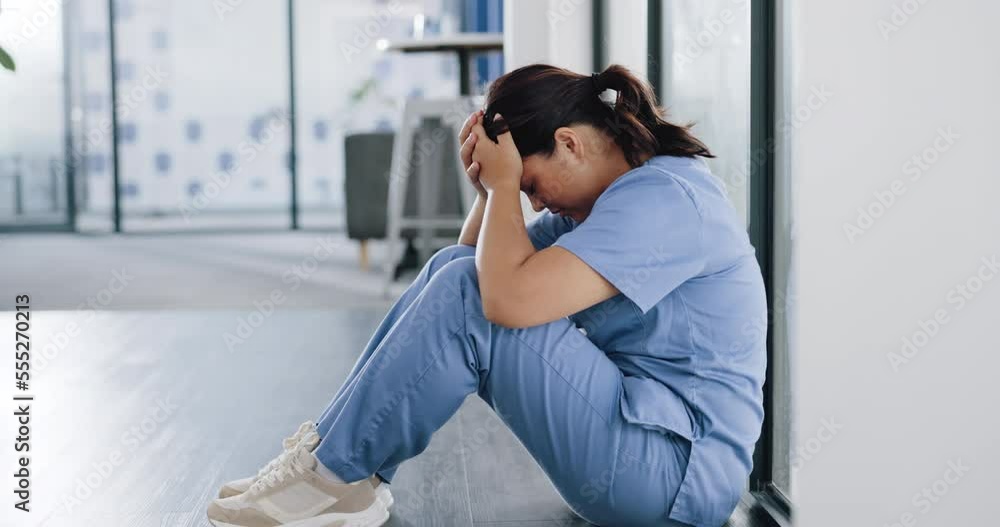 Healthcare, stress and sad nurse on floor with burnout, anxiety and ...