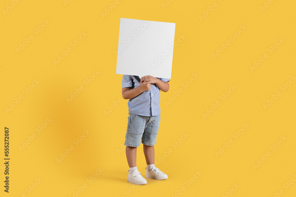 Kids mood. Adorable unrecognizable little boy posing with blank sheet ...