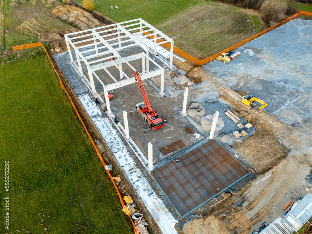 Prefabricated concrete skeleton frame building being constructed, building site, aerial view ...